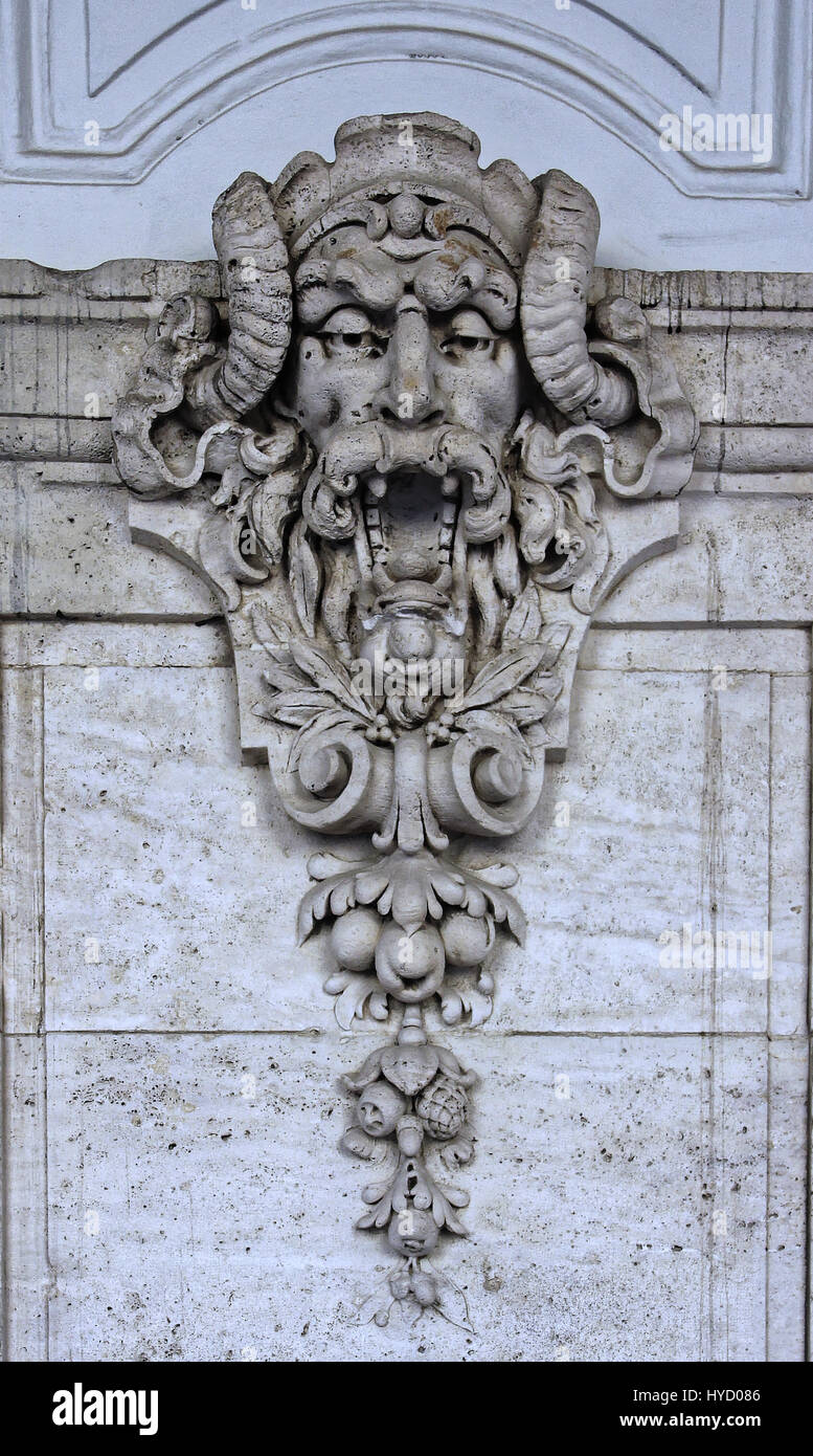 Castle building is decorated with carved stone face Stock Photo - Alamy