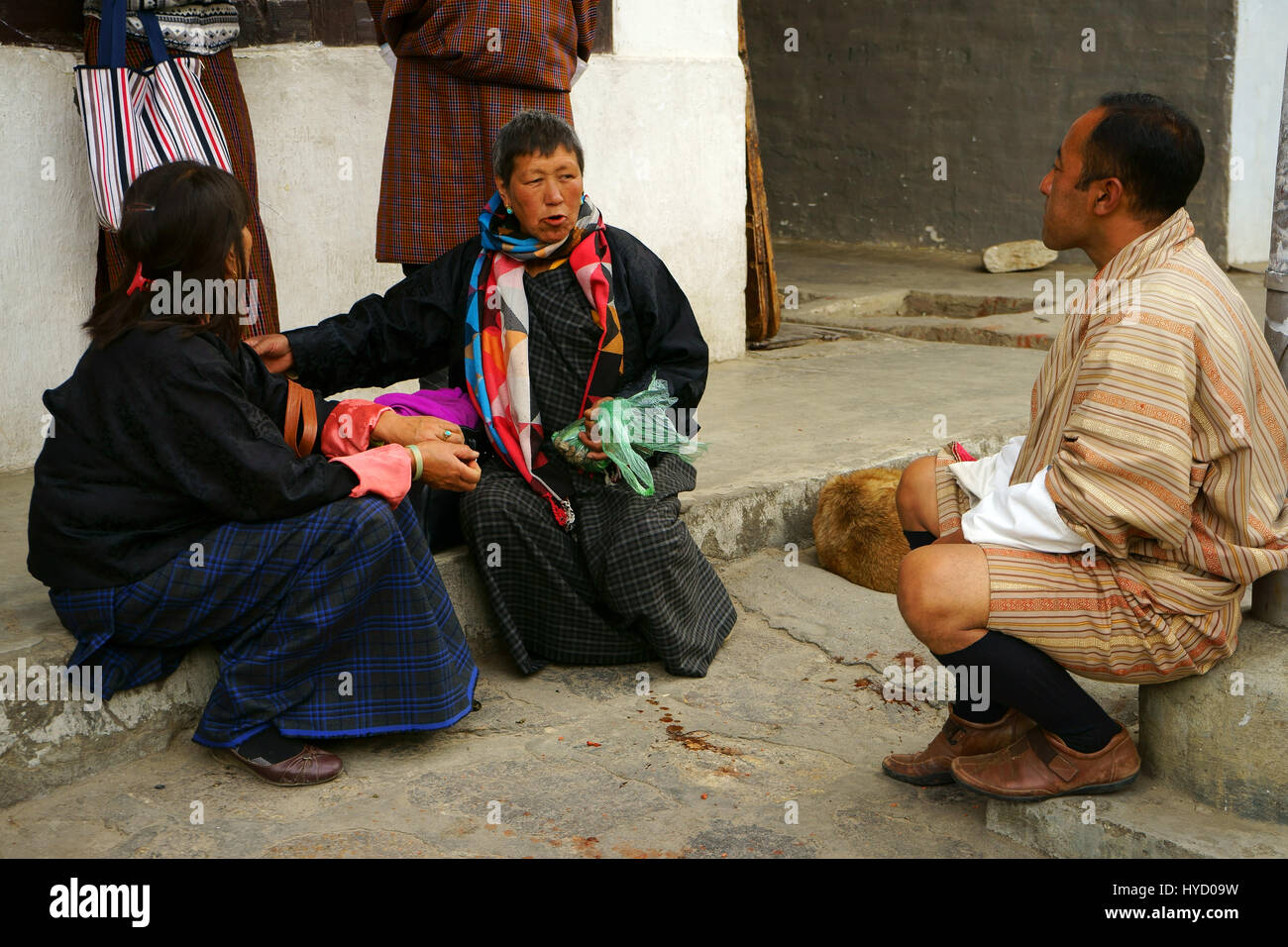 Bhutan local people in traditional cloth chatting on boardwalk and ...