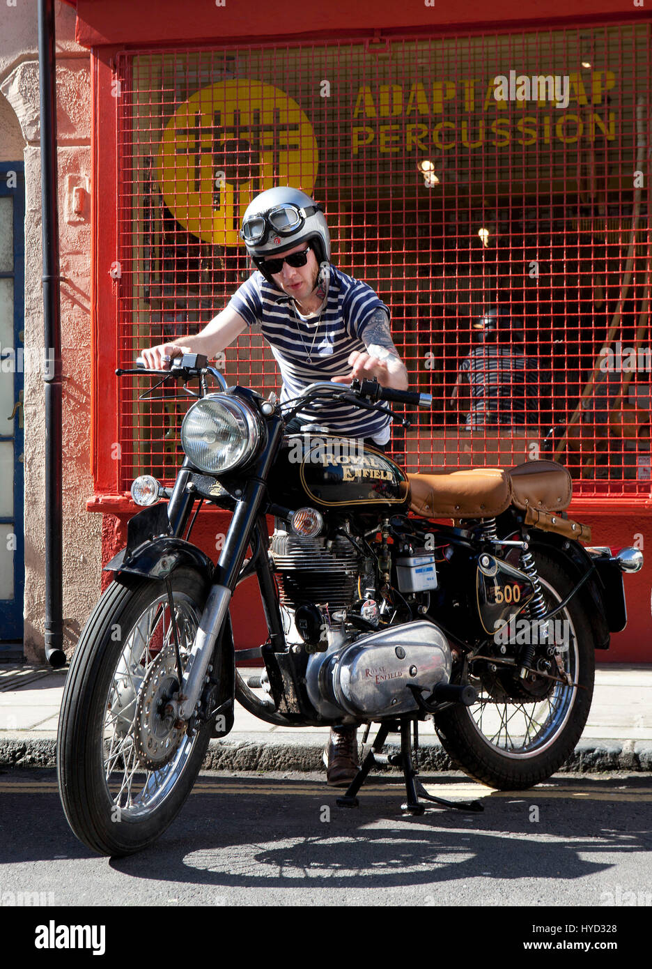Young man with his Royal Enfield motorcycle Stock Photo - Alamy