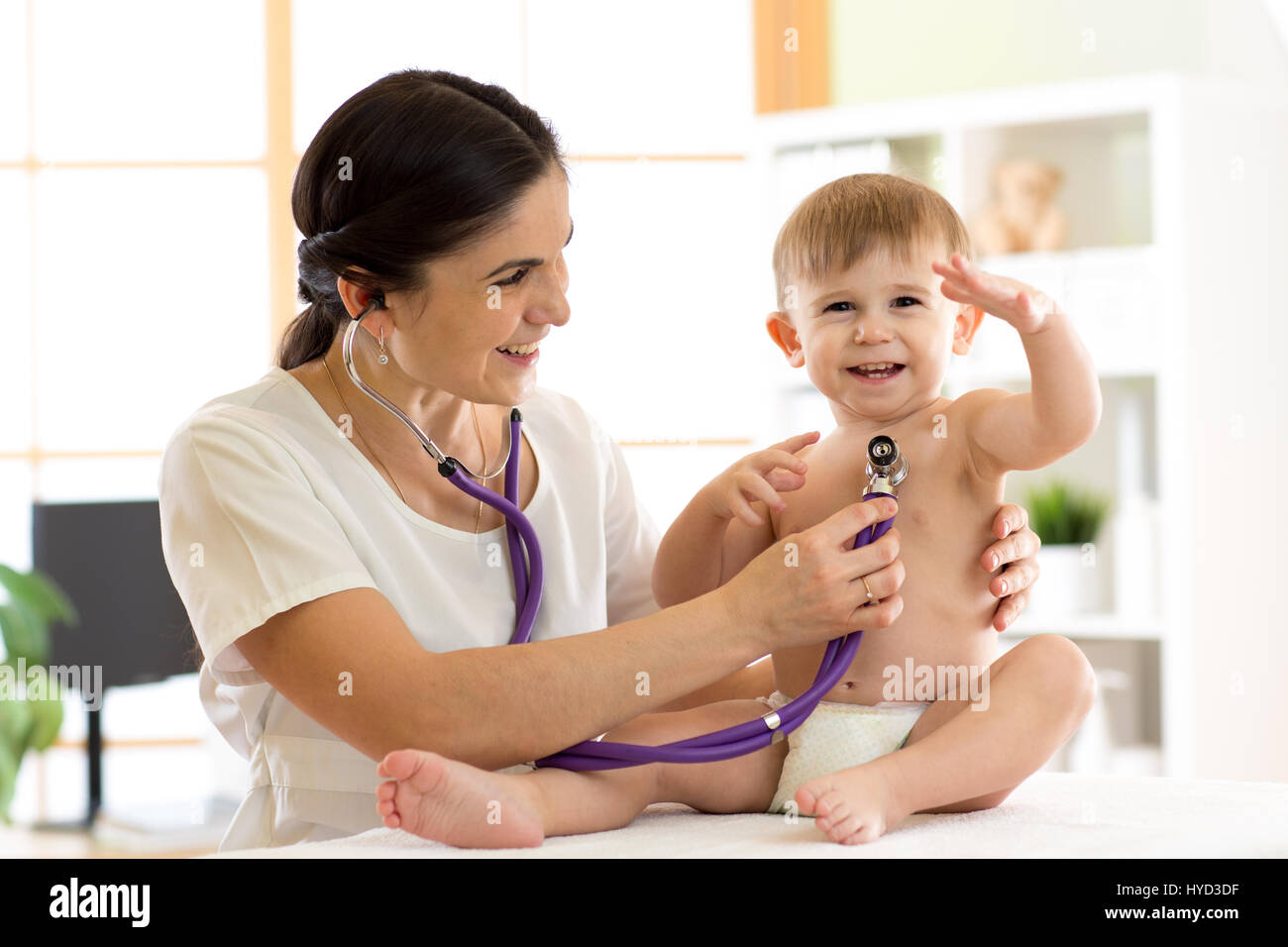 woman pediatrician examining of baby kid with stethoscope Stock Photo ...