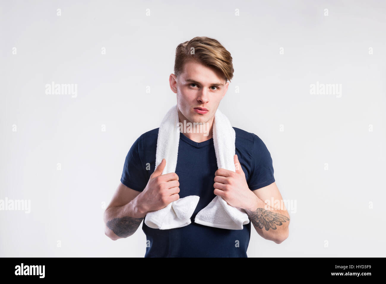 Fitness man resting after working out, towel around neck Stock Photo ...
