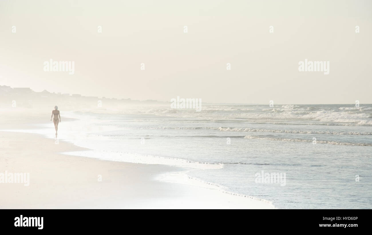 USA, North Carolina, Woman walking on empty beach Stock Photo - Alamy