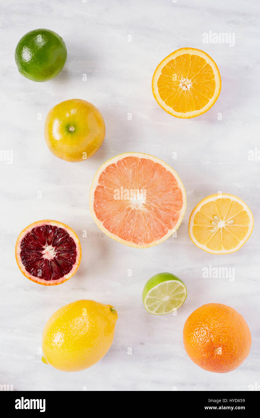Various citrus fruits on marble counter Stock Photo - Alamy