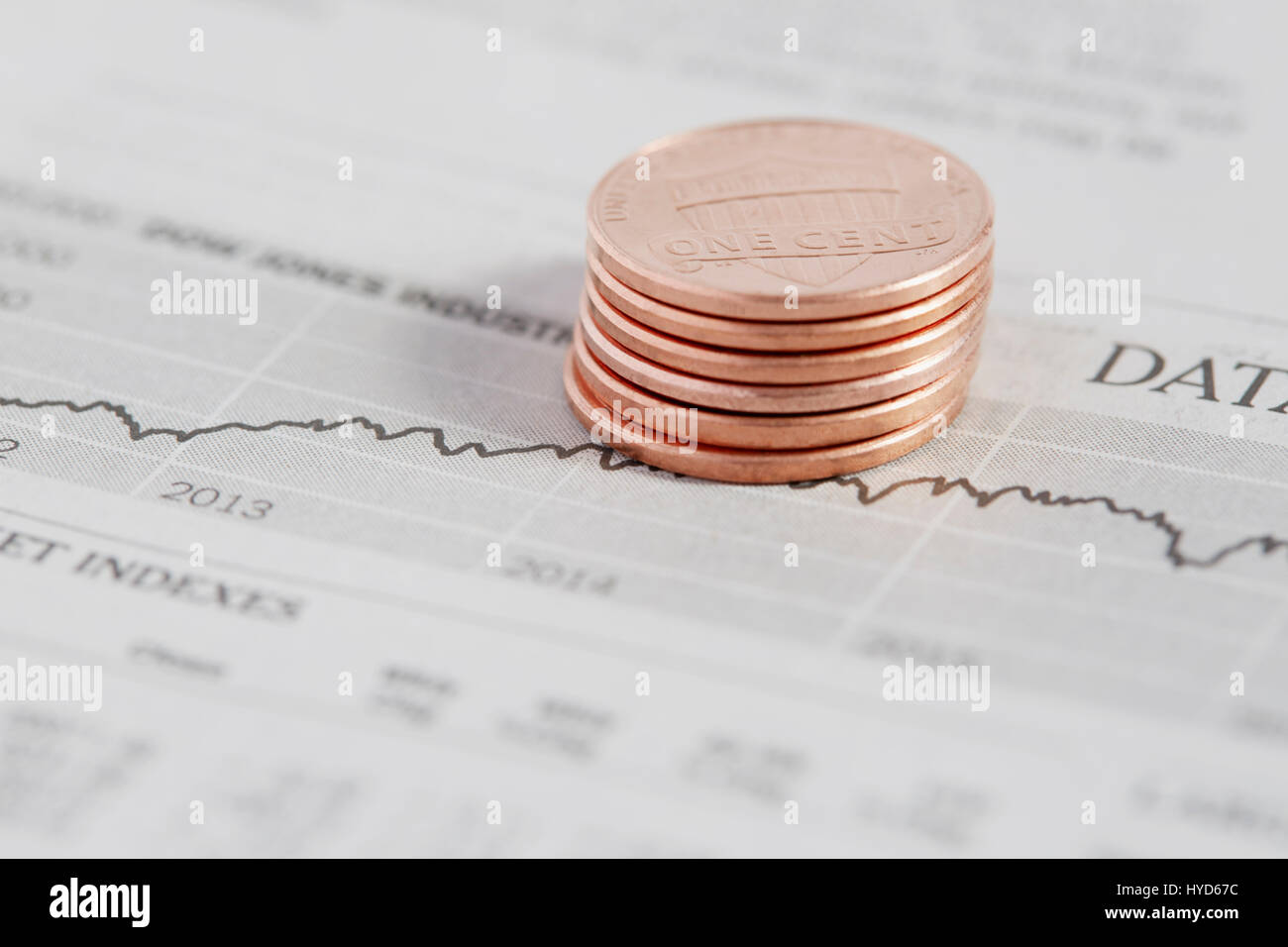 Stack of coins on stock market data Stock Photo - Alamy