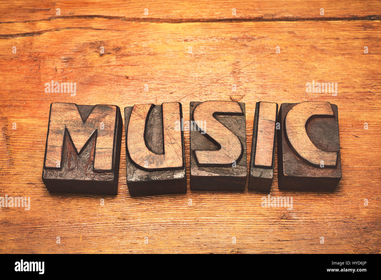 music word made from scattered vintage letterpress blocks on wooden ...