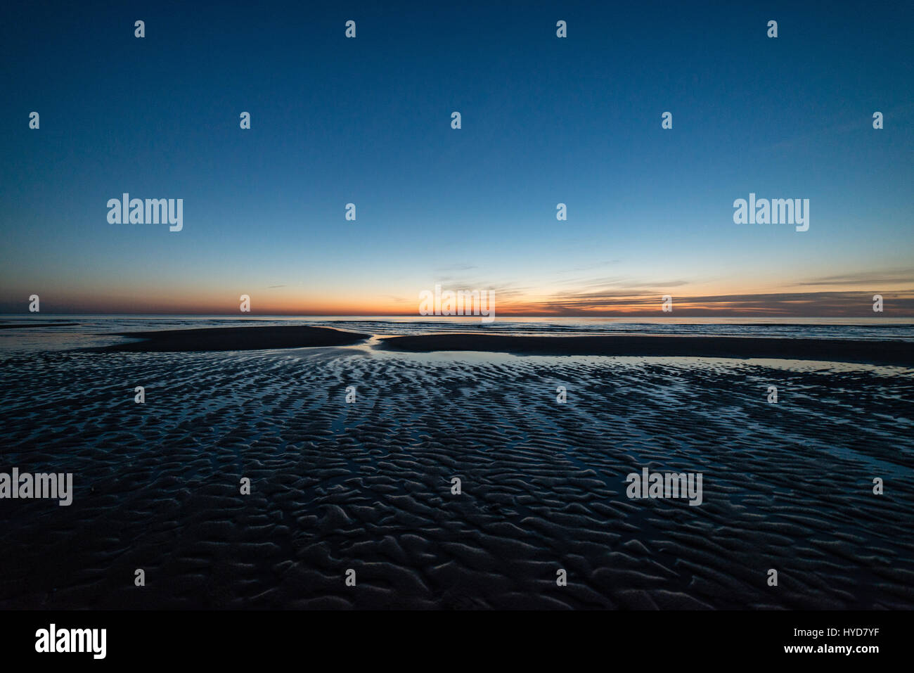 Beautiful sunset over the sea with clouds and reflections Stock Photo ...
