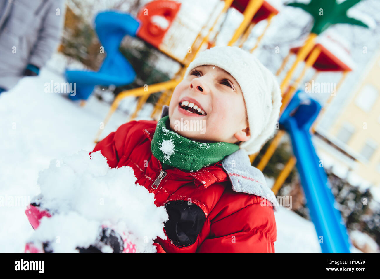 Girl holding big snowball and smiling Stock Photo - Alamy