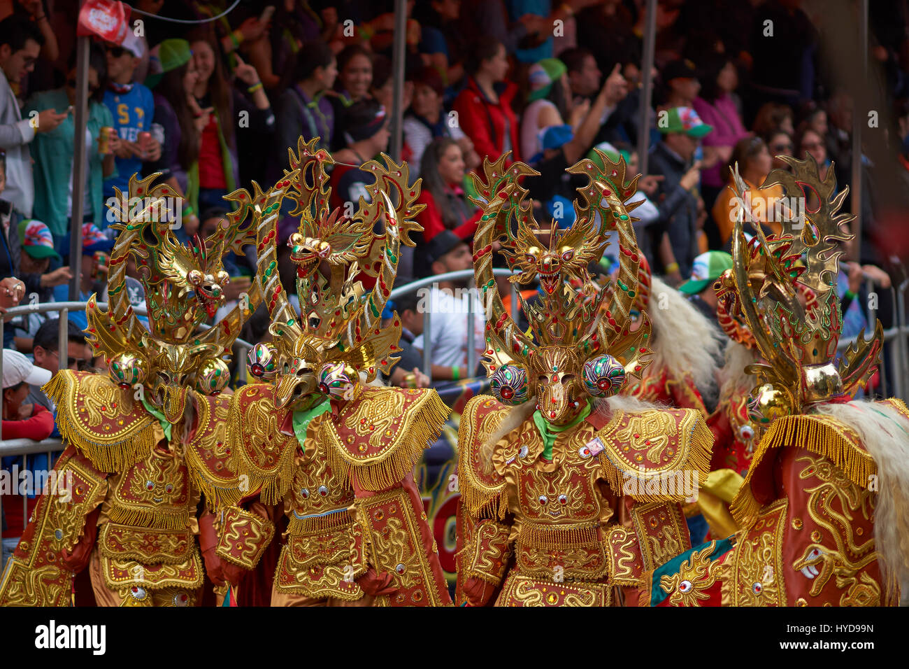 Masked Diablada dancers in ornate costumes parade through the mining ...