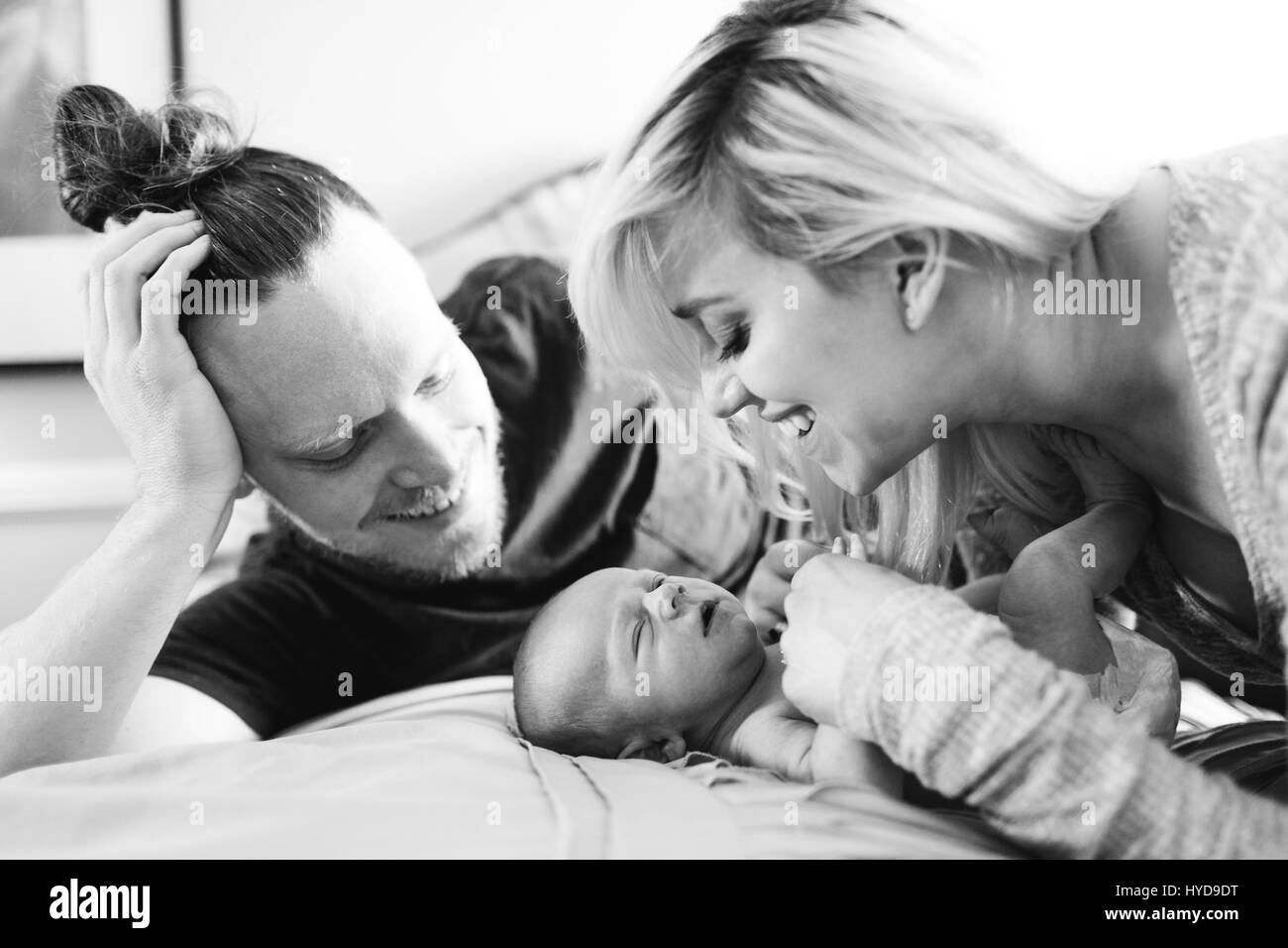 Parents kissing boy Black and White Stock Photos & Images - Alamy