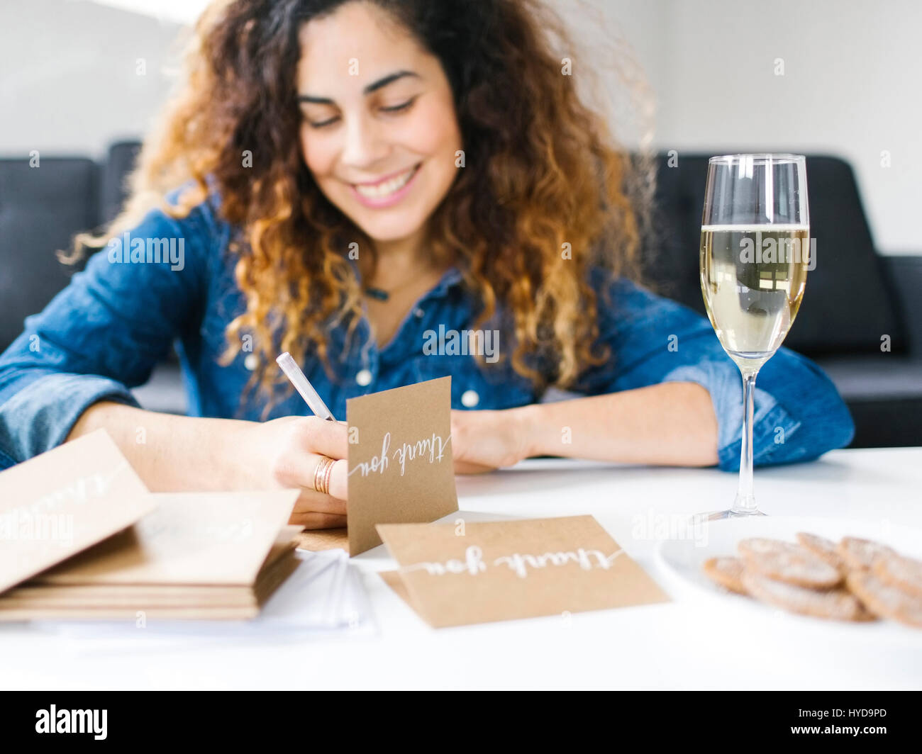 Woman handwriting in living room Stock Photo - Alamy