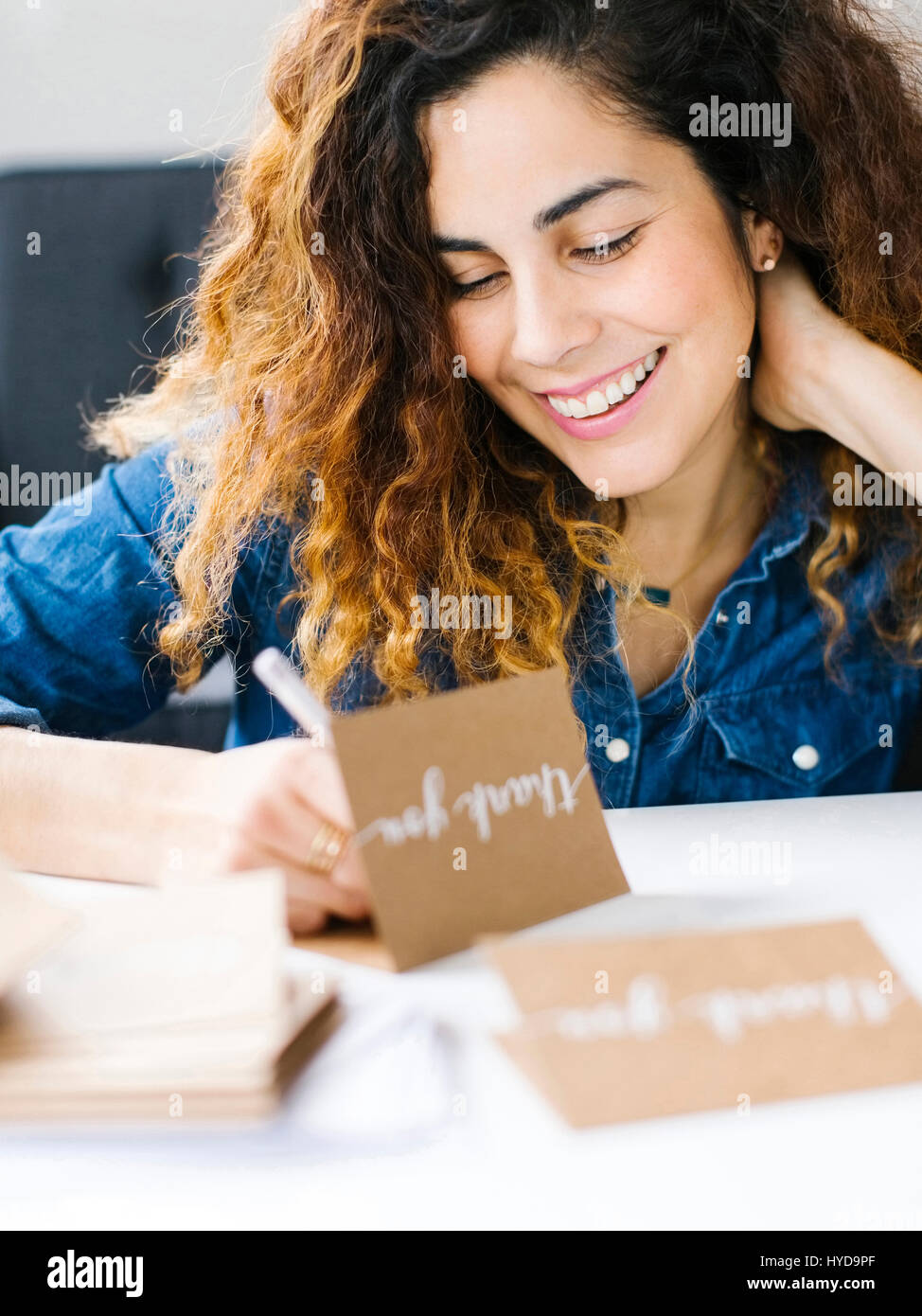 Woman handwriting in living room Stock Photo - Alamy