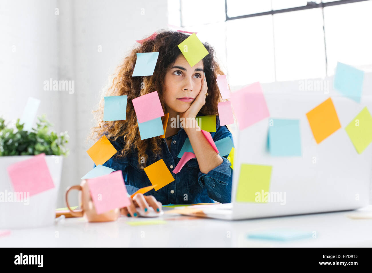 Woman covered with sticky notes using laptop at table Stock Photo - Alamy