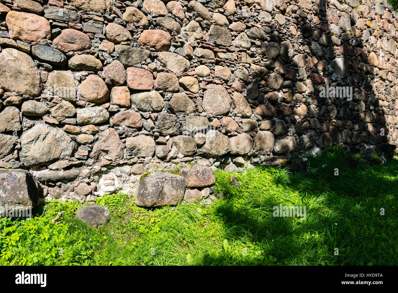 ancient stone brick wall background texture with green grass Stock ...