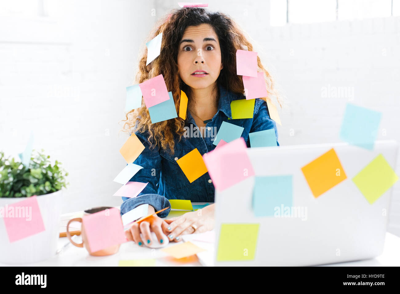 Woman covered with sticky notes using laptop at table Stock Photo - Alamy