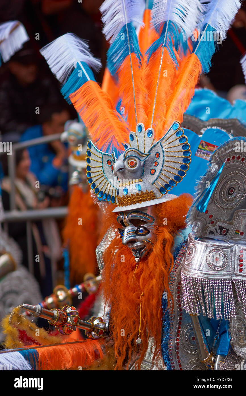 Masked Morenada dancers in ornate costumes parading through the mining ...