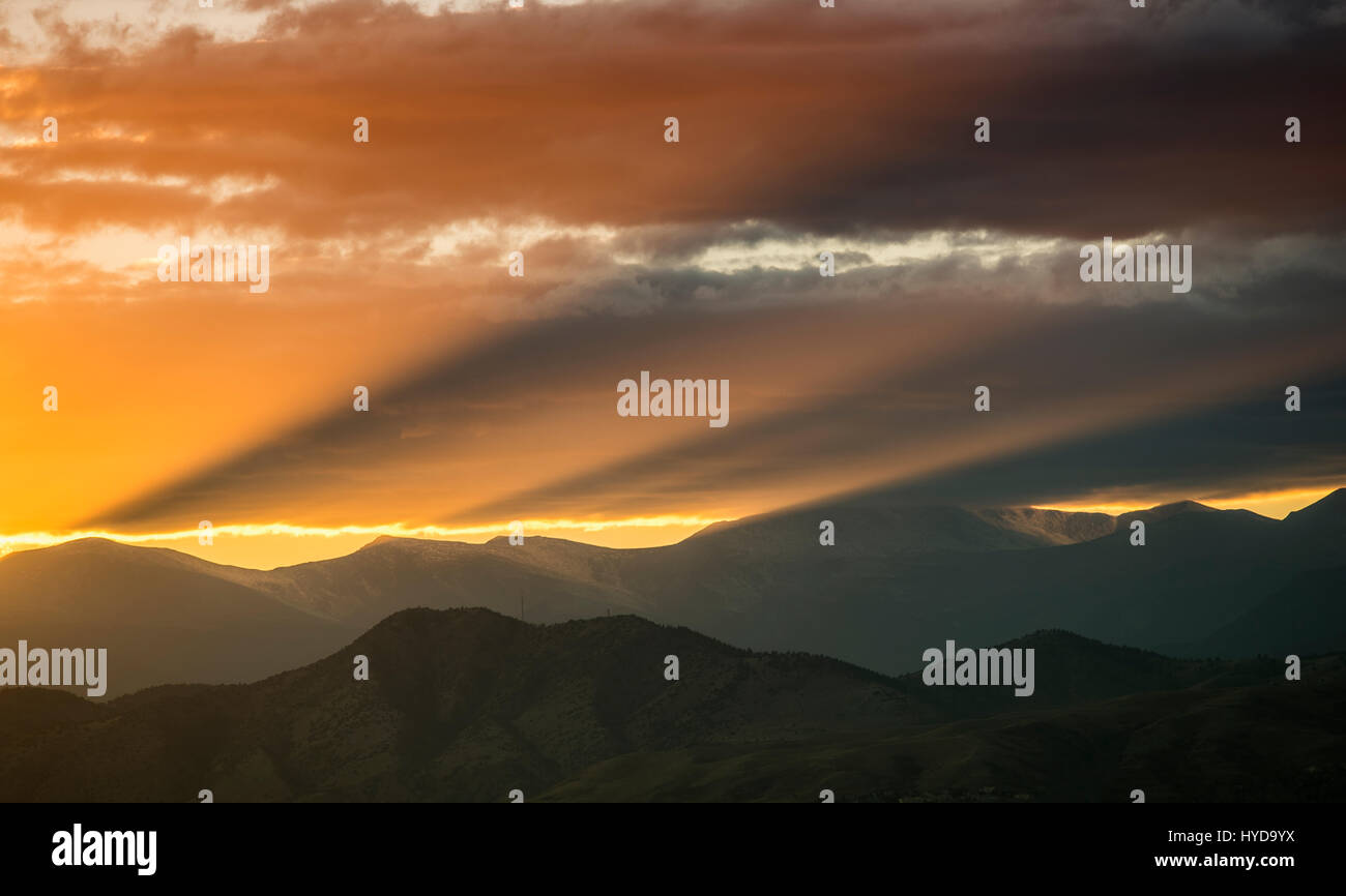 USA, COLORADO, FRONT RANGE, SUNS RAYS BEHIND THE FRONT RANGE IN LATE ...