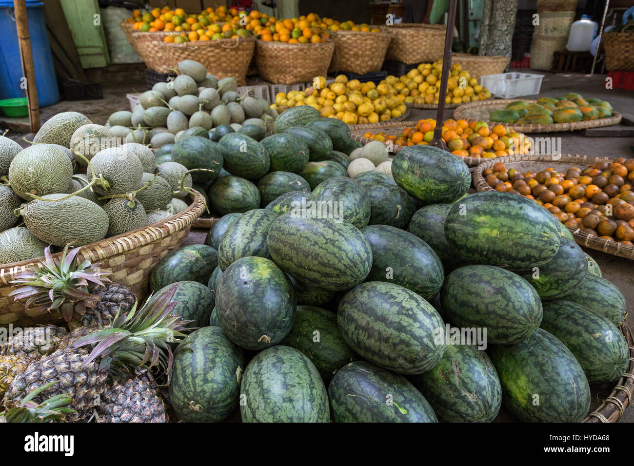 A lot of watermelons and many other fruits in woven baskets at the ...