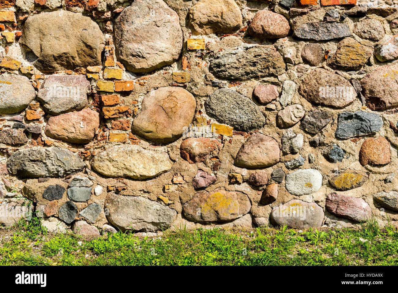 ancient stone brick wall background texture with green grass Stock ...