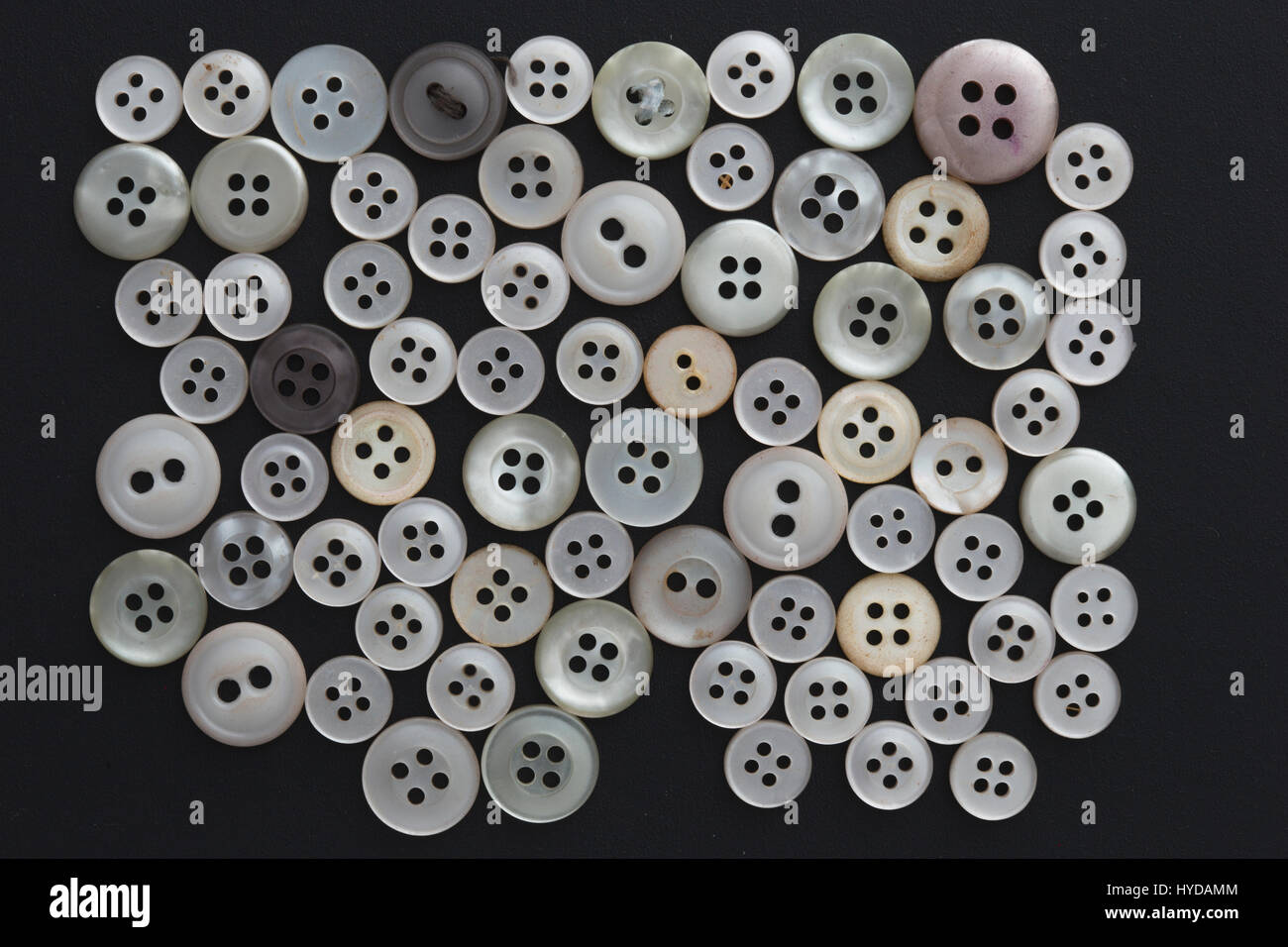 Studio shot of grey buttons on black background Stock Photo - Alamy