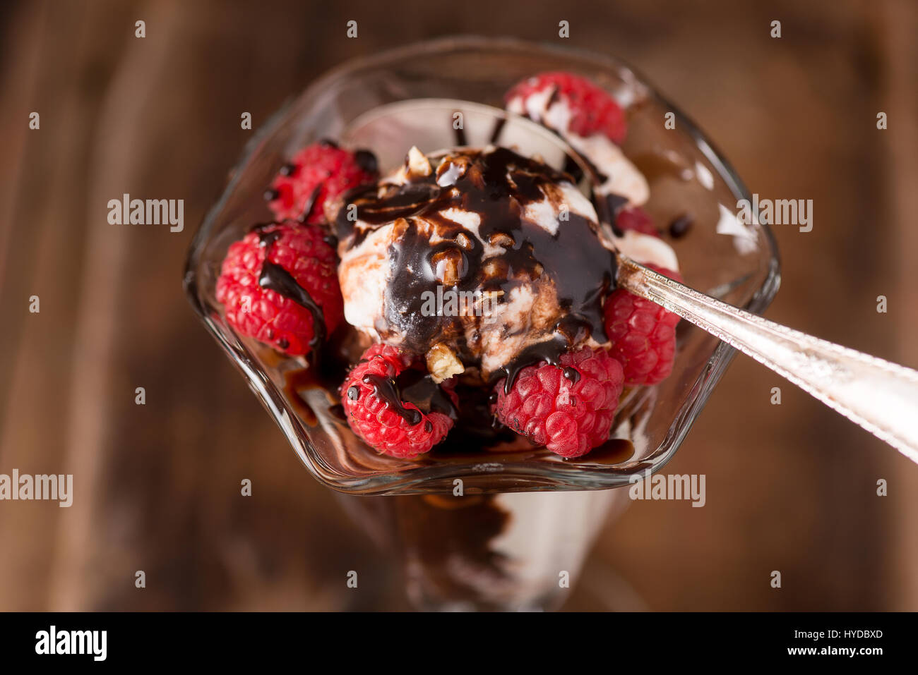 Ice cream sundae in vintage glass with chocolate sauce, nuts and ...