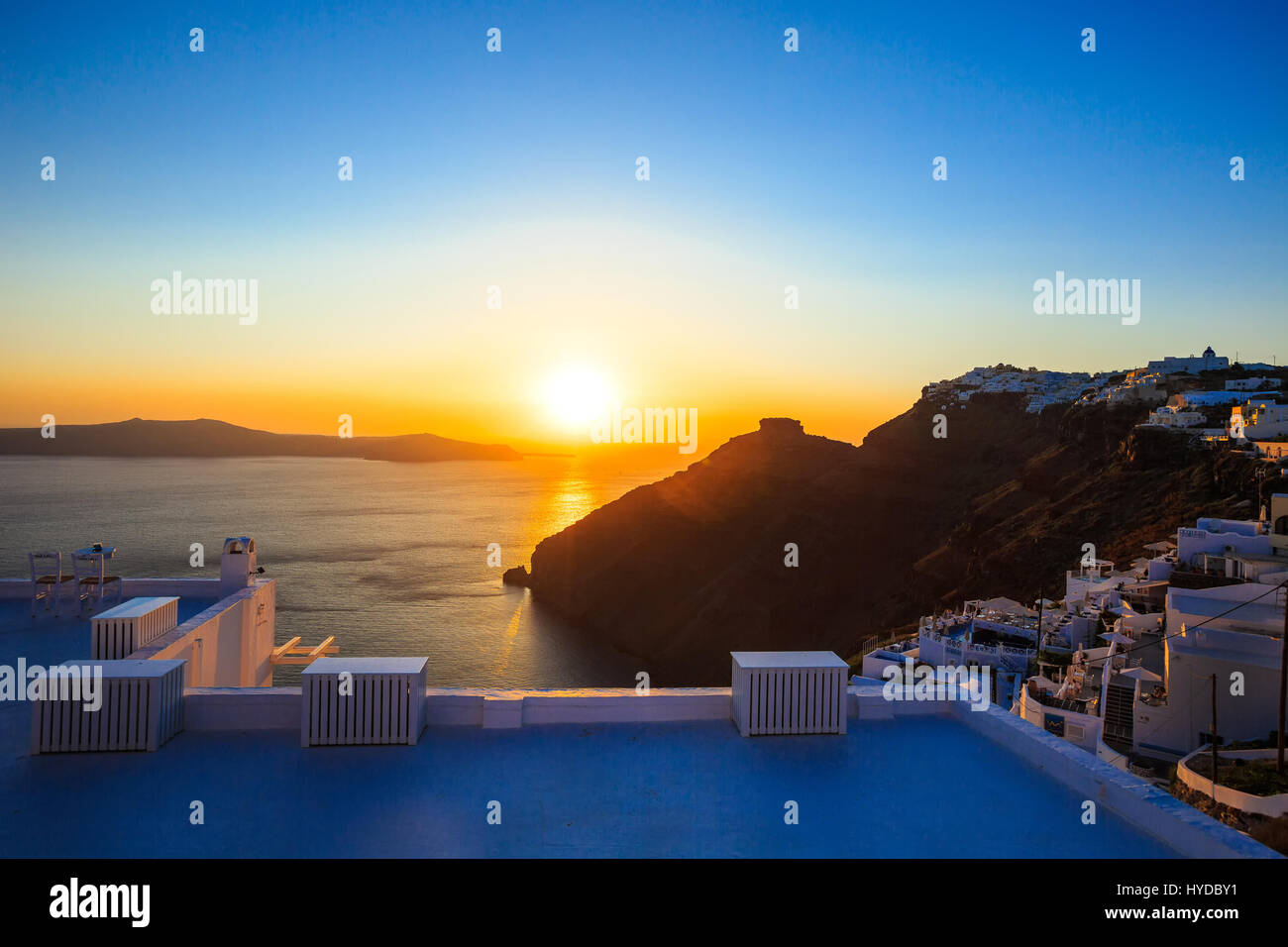 Beautiful typical white greek terrace with benches . Sea side of Thira ...