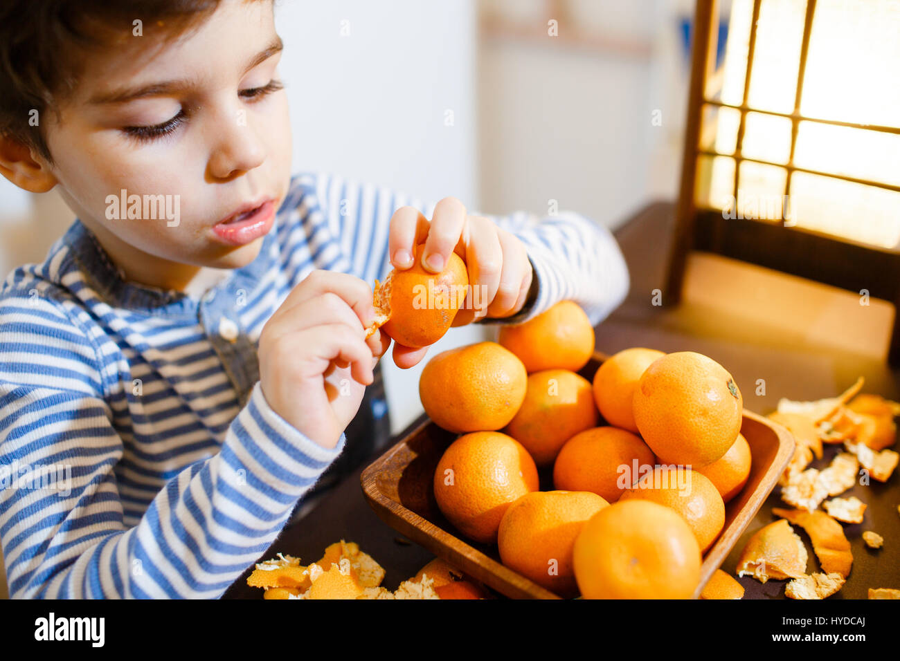 4-years boy eat a mandarin with great pleasure Stock Photo - Alamy