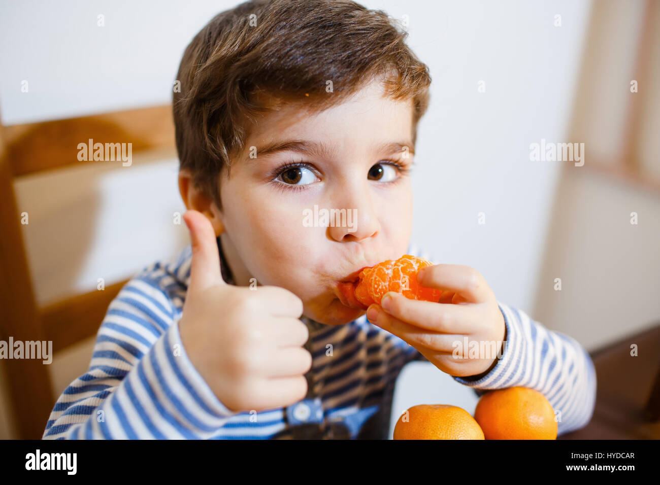 Boy holding mandarin fruit hi-res stock photography and images - Alamy