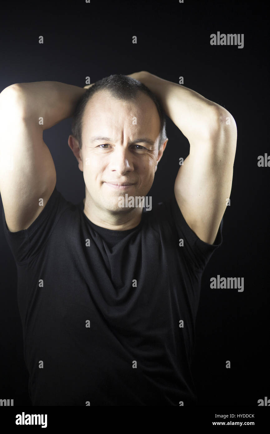 Attractive handsome slim healthy man aged in 40's in black t-shirt ...