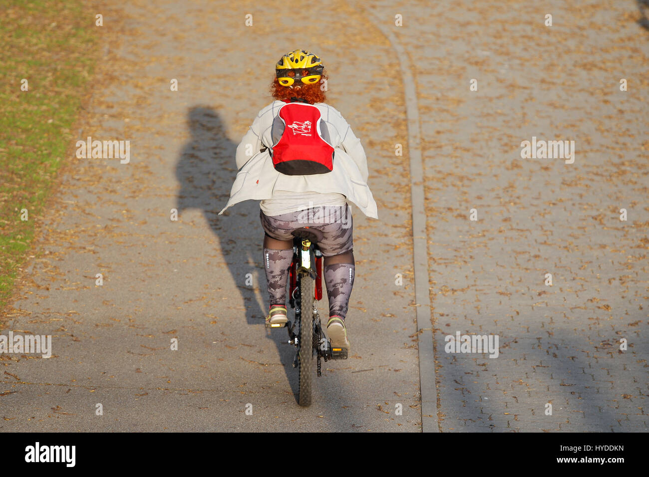 People are seen enjoying the warm Spring weather near the river side in ...