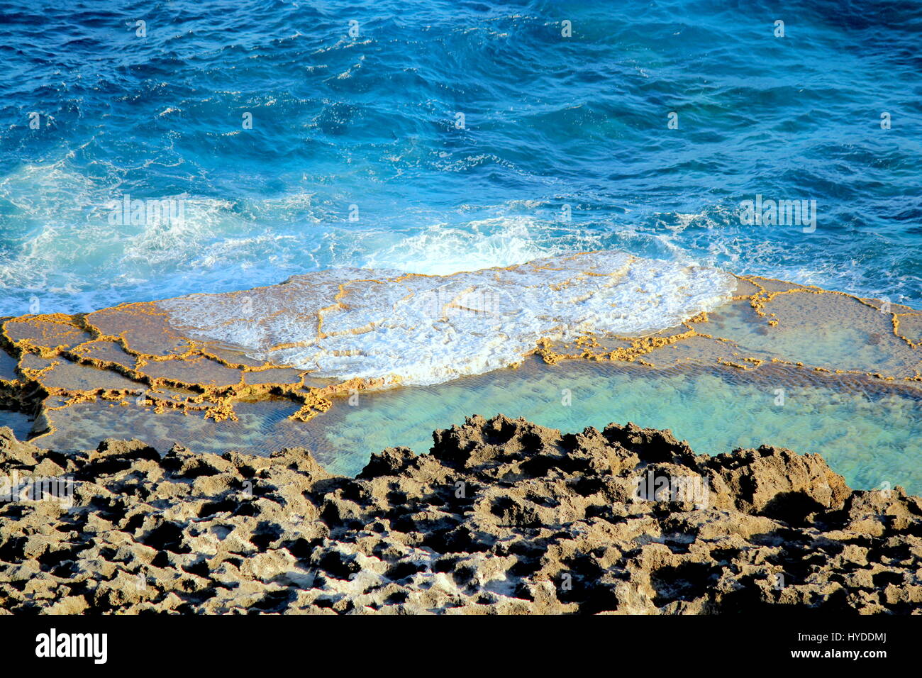Rocky Pool, Rota A rocky pool formed around corals at the foot of the ...