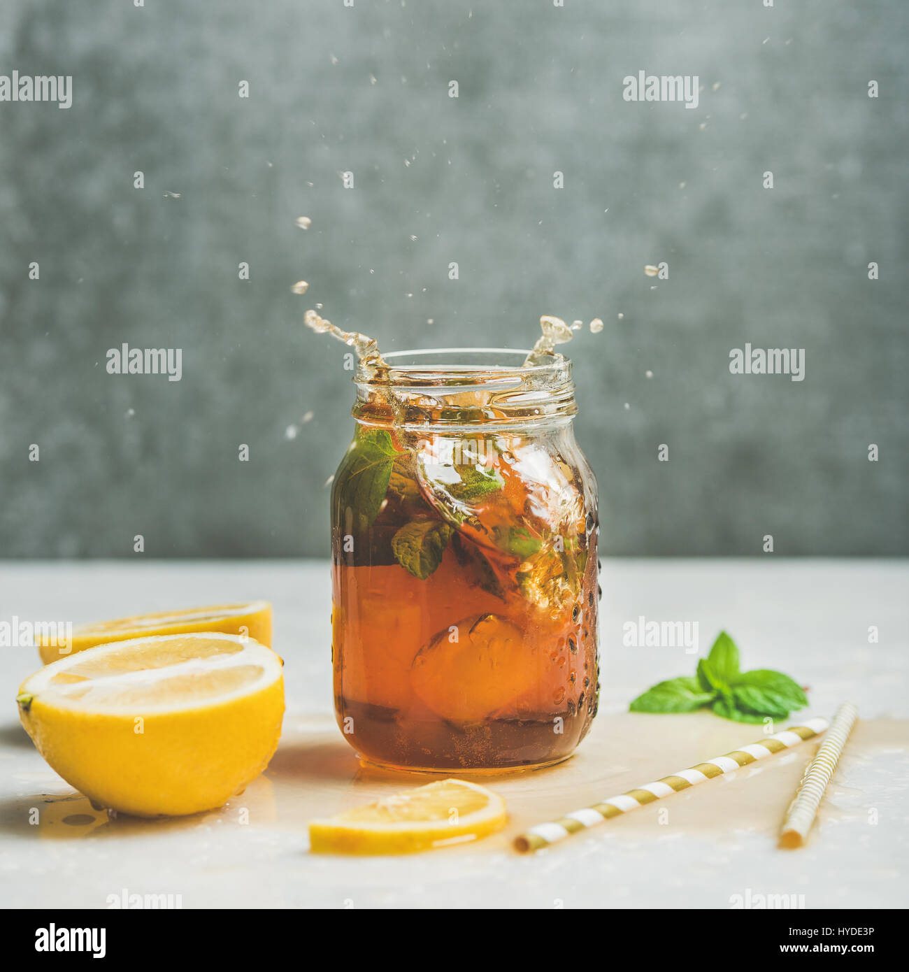 Summer Iced tea with lemon and herbs, square crop Stock Photo - Alamy