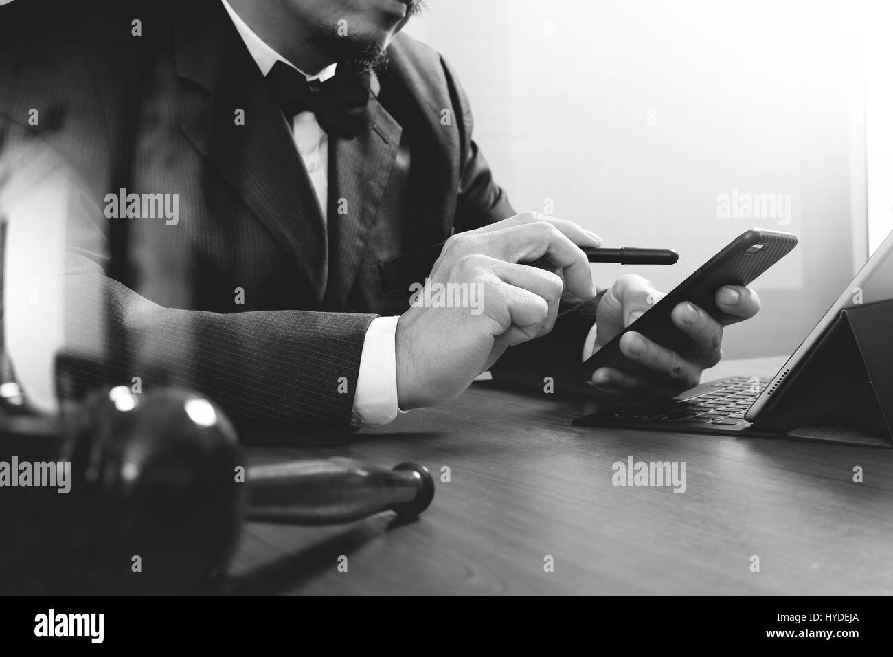 Justice and Law context.Male lawyer hand working with smart phone ...