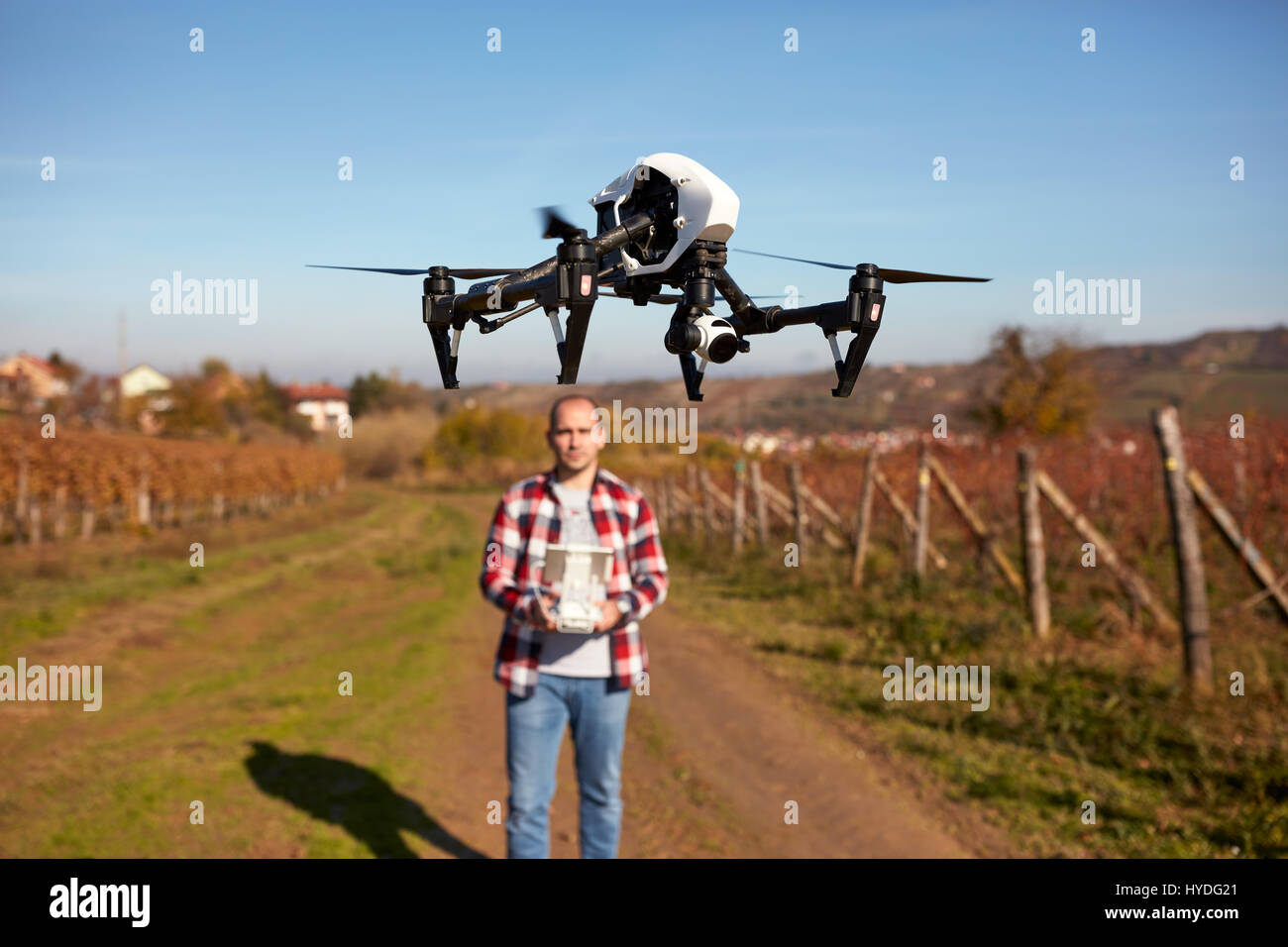 Drone hovering over ground and filming vineyard Stock Photo - Alamy