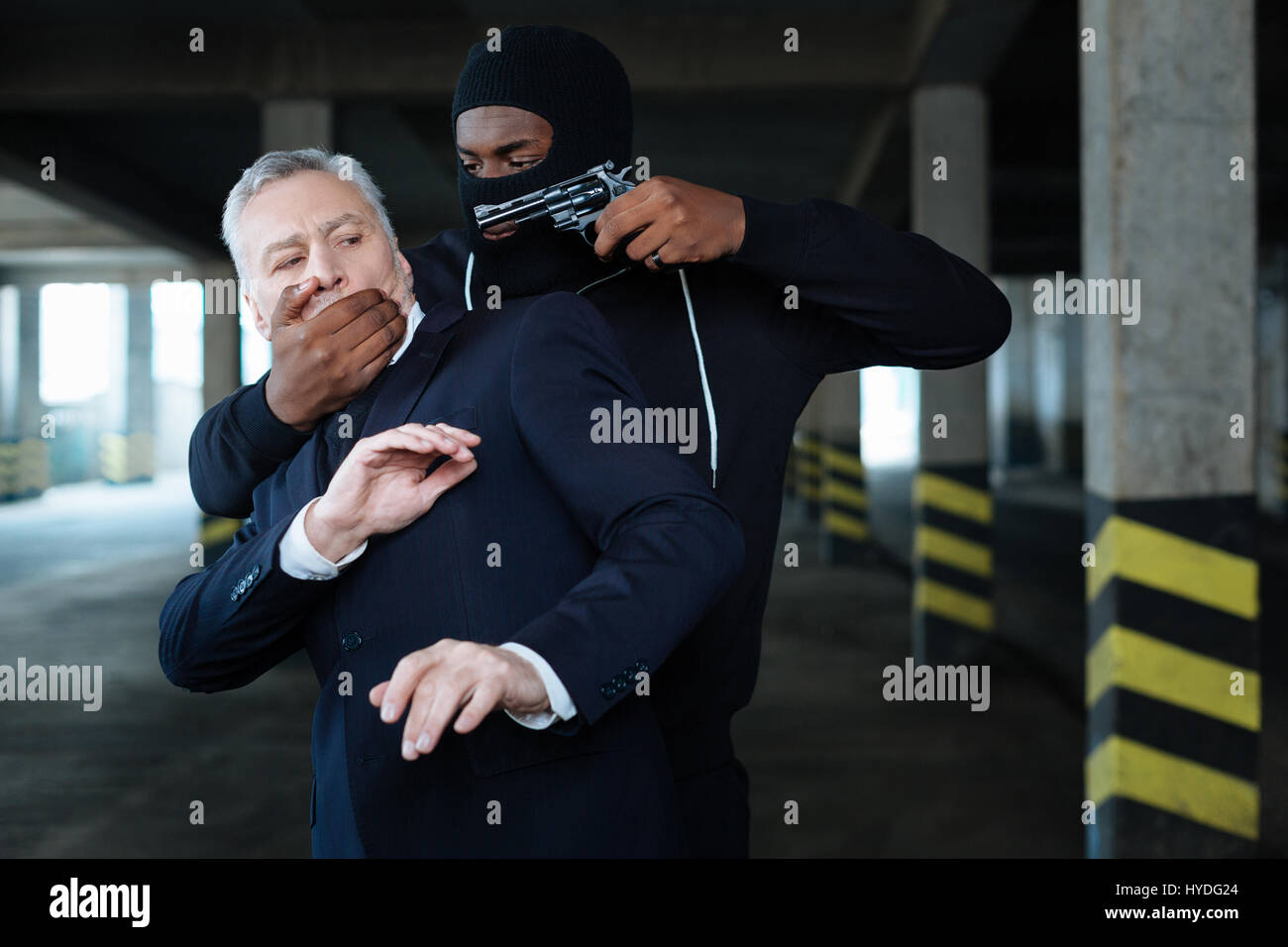Aggressive dangerous criminal kidnapping a businessman Stock Photo - Alamy