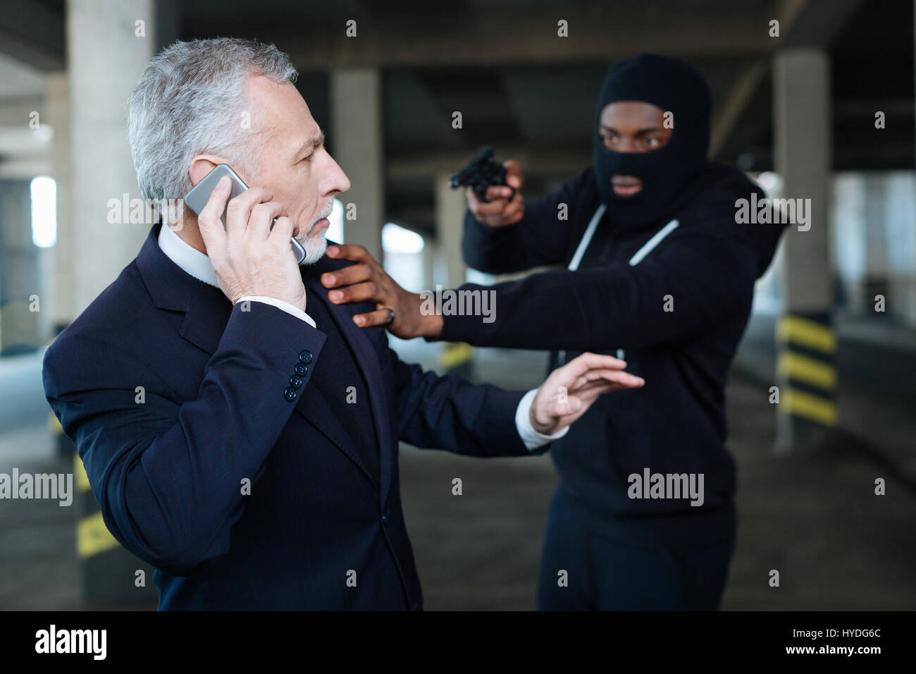 Aggressive male robber committing a crime Stock Photo - Alamy