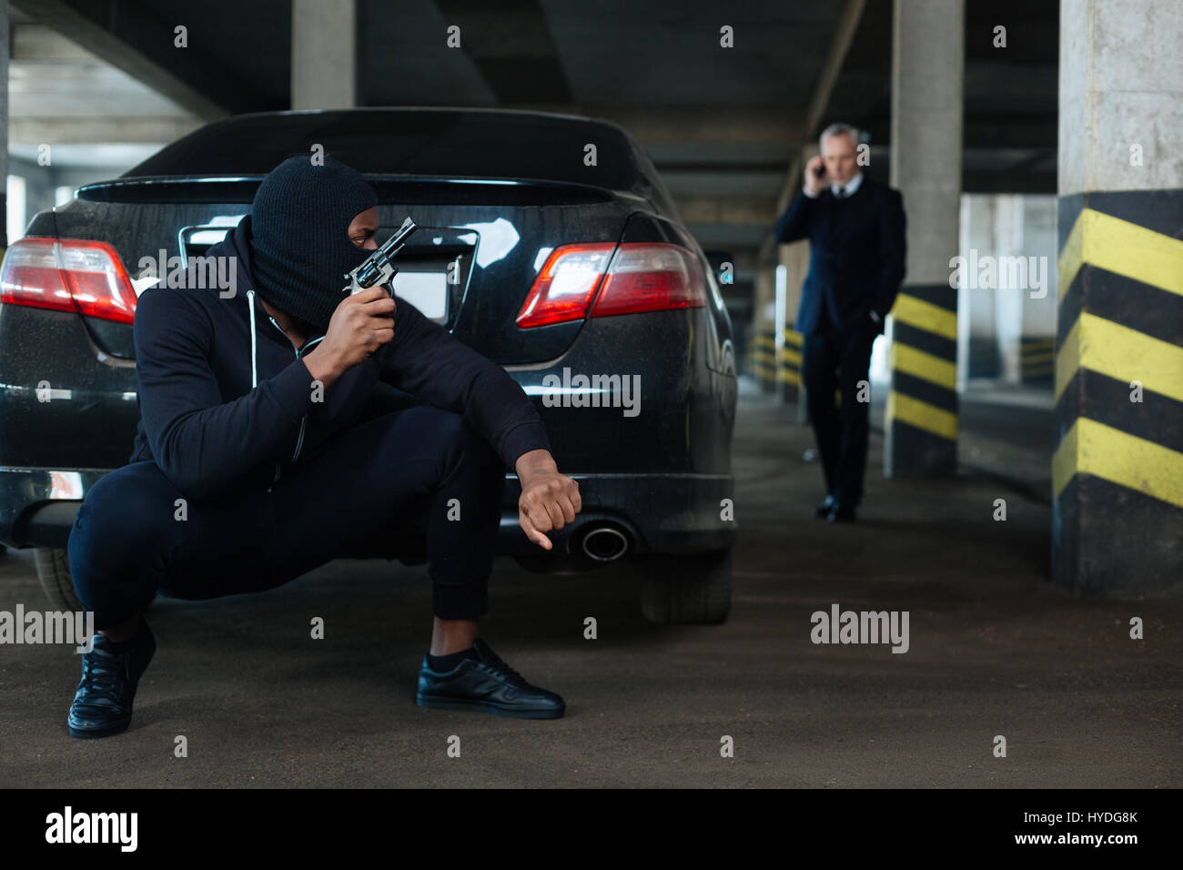 Dangerous well built criminal sitting in ambush Stock Photo - Alamy