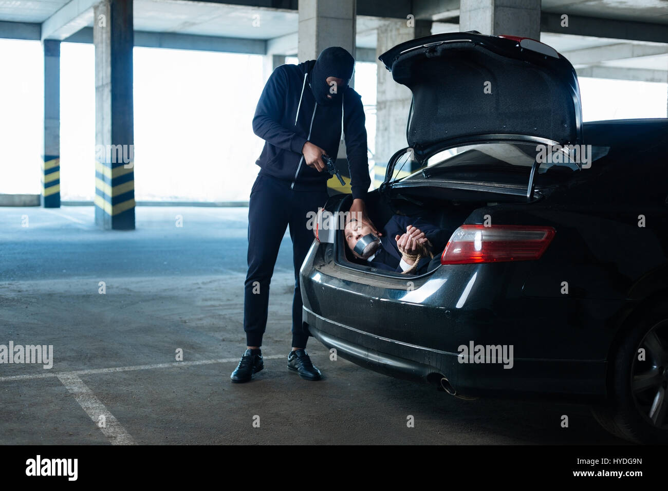Angry male criminal looking at his victim Stock Photo - Alamy