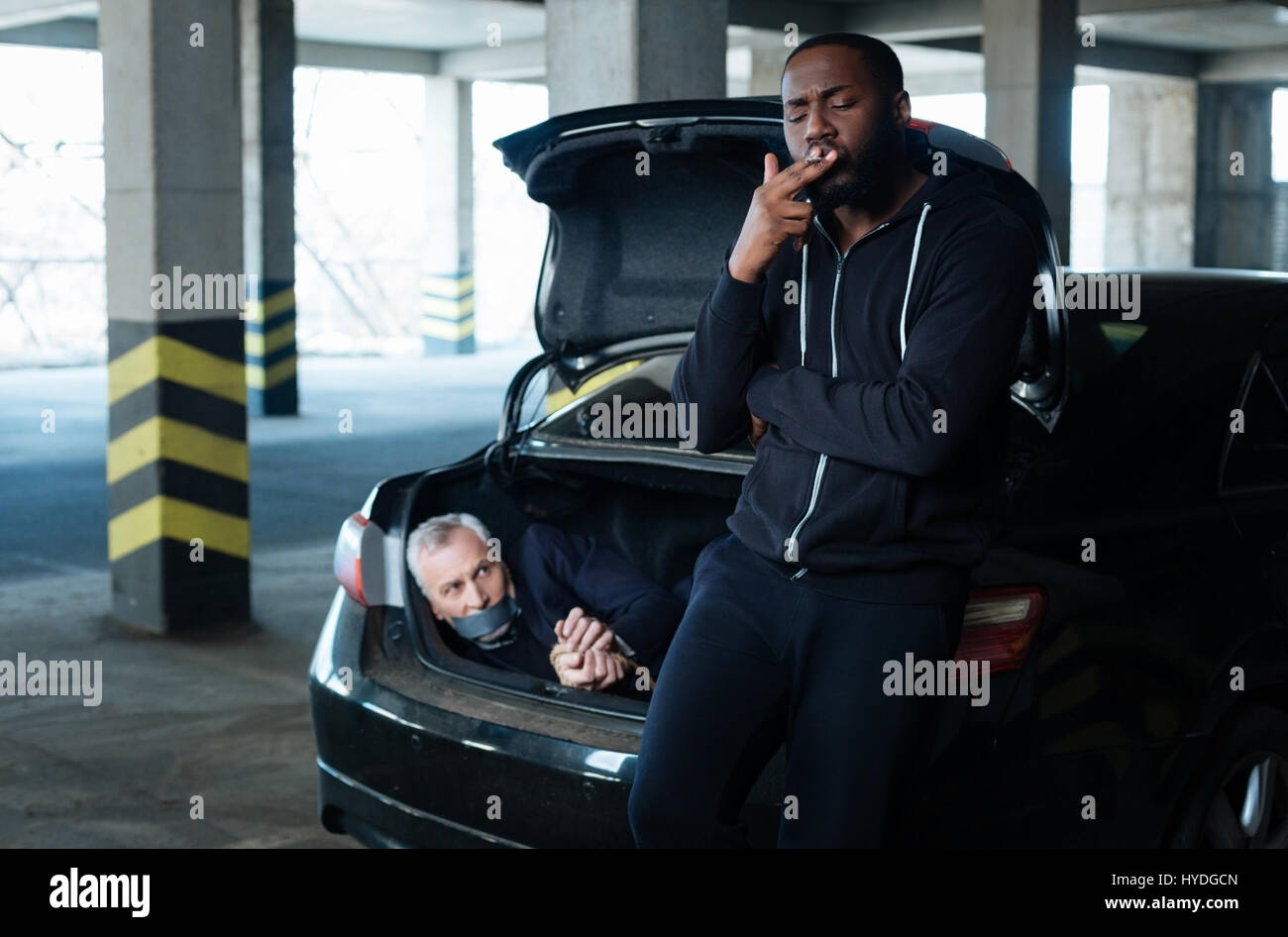 Nice relaxed man smoking a cigarette Stock Photo - Alamy