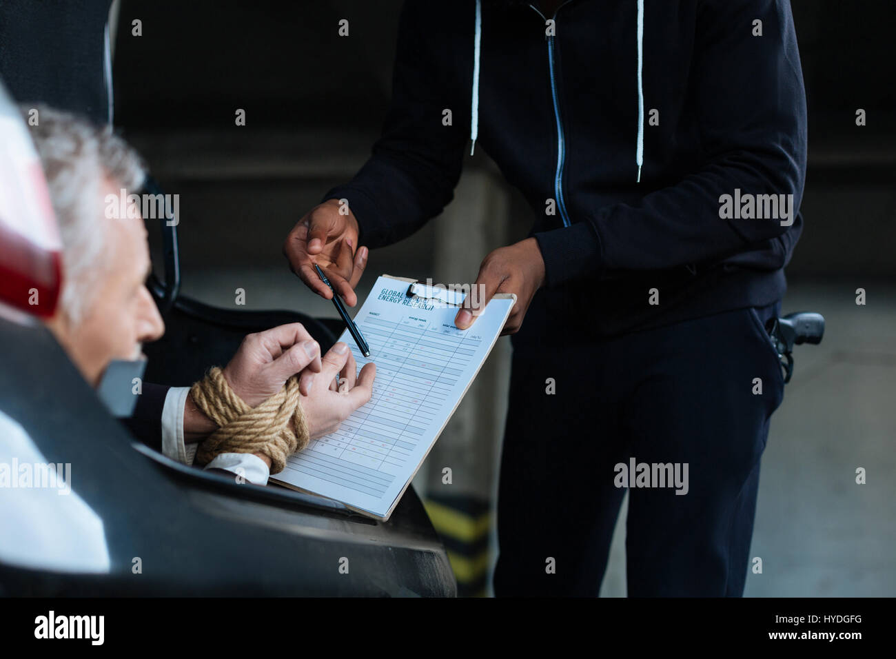 Sign this. Unhappy sad serious man having his hands tied and being ...