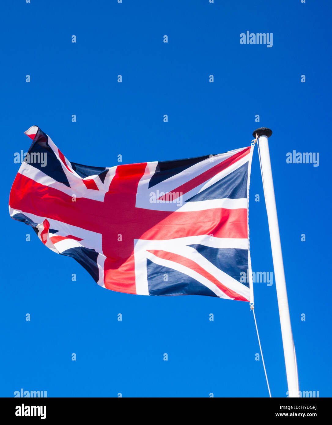 Union Jack flag against blue sky Stock Photo - Alamy