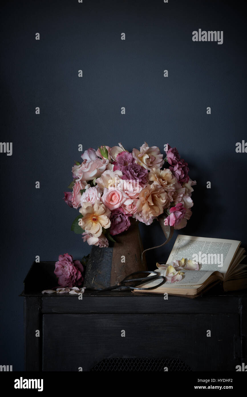 Collection iof pastel coloured roses in rustic setting. Still life ...