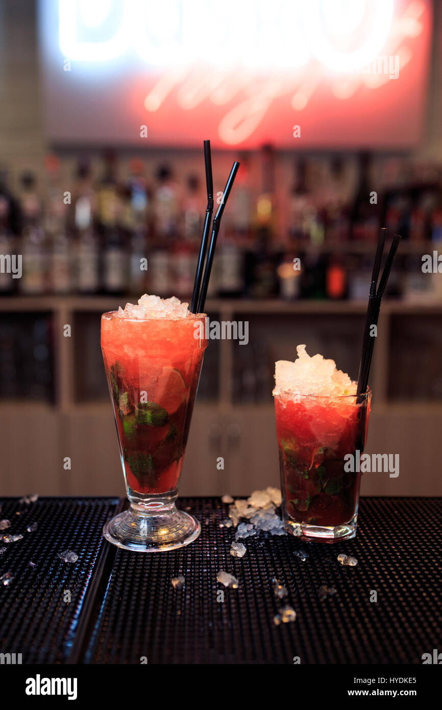 two red cocktails with ice in bar Stock Photo - Alamy