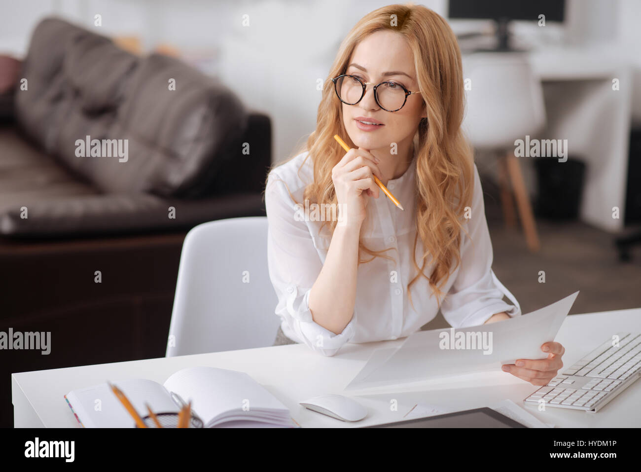 Inspired young manager working on the project in the office Stock Photo ...