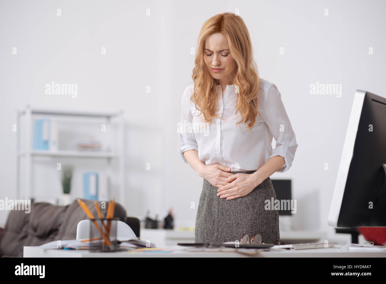 Suffering from monthly women problem. Sick miserable young secretary ...