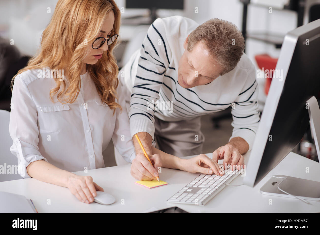 Positive office managers collaborating at the workplace Stock Photo - Alamy