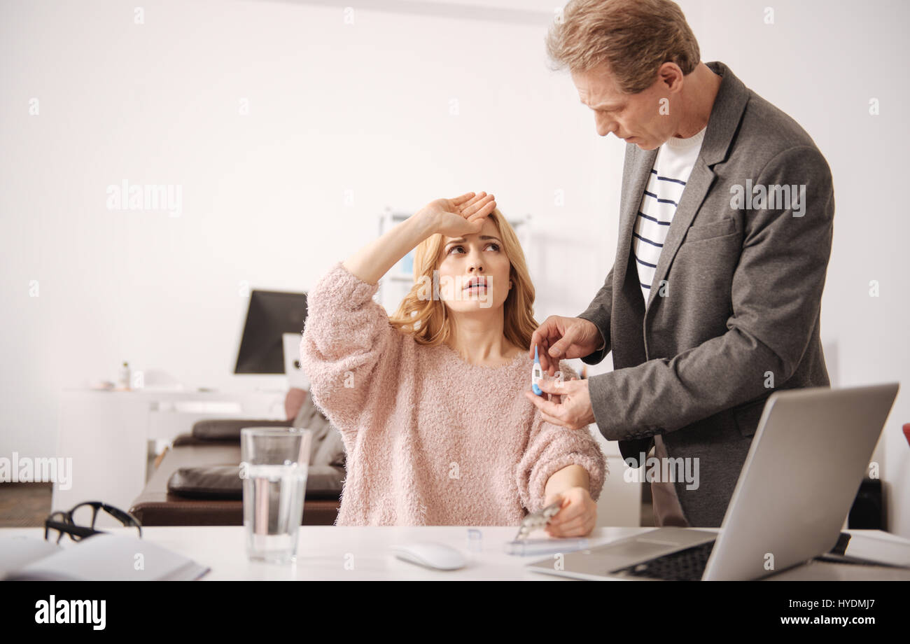 Upset young manager having high temperature in the office Stock Photo ...