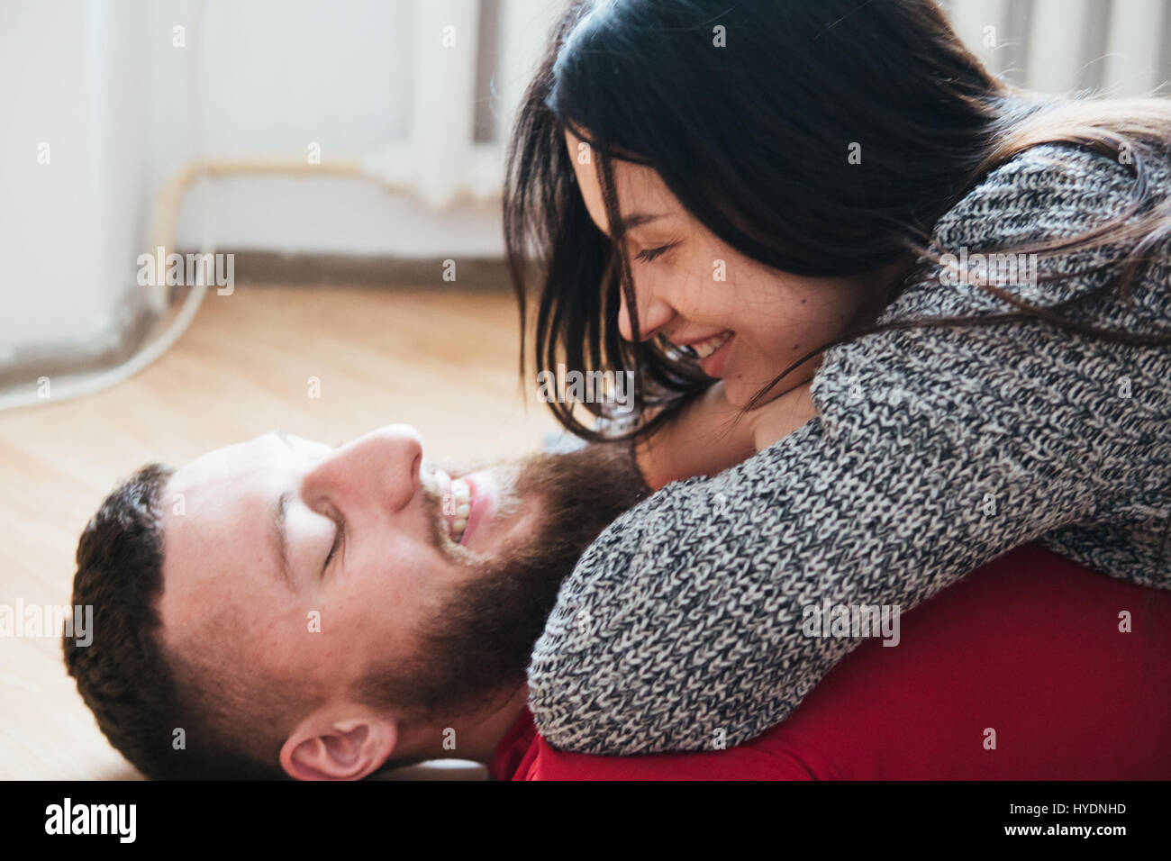 Man and woman lying together on the wooden floor hi-res stock ...