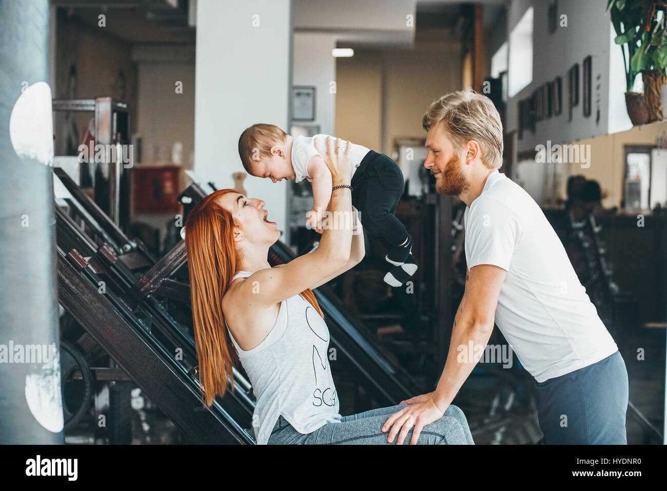Young family with little boy in the gym Stock Photo - Alamy