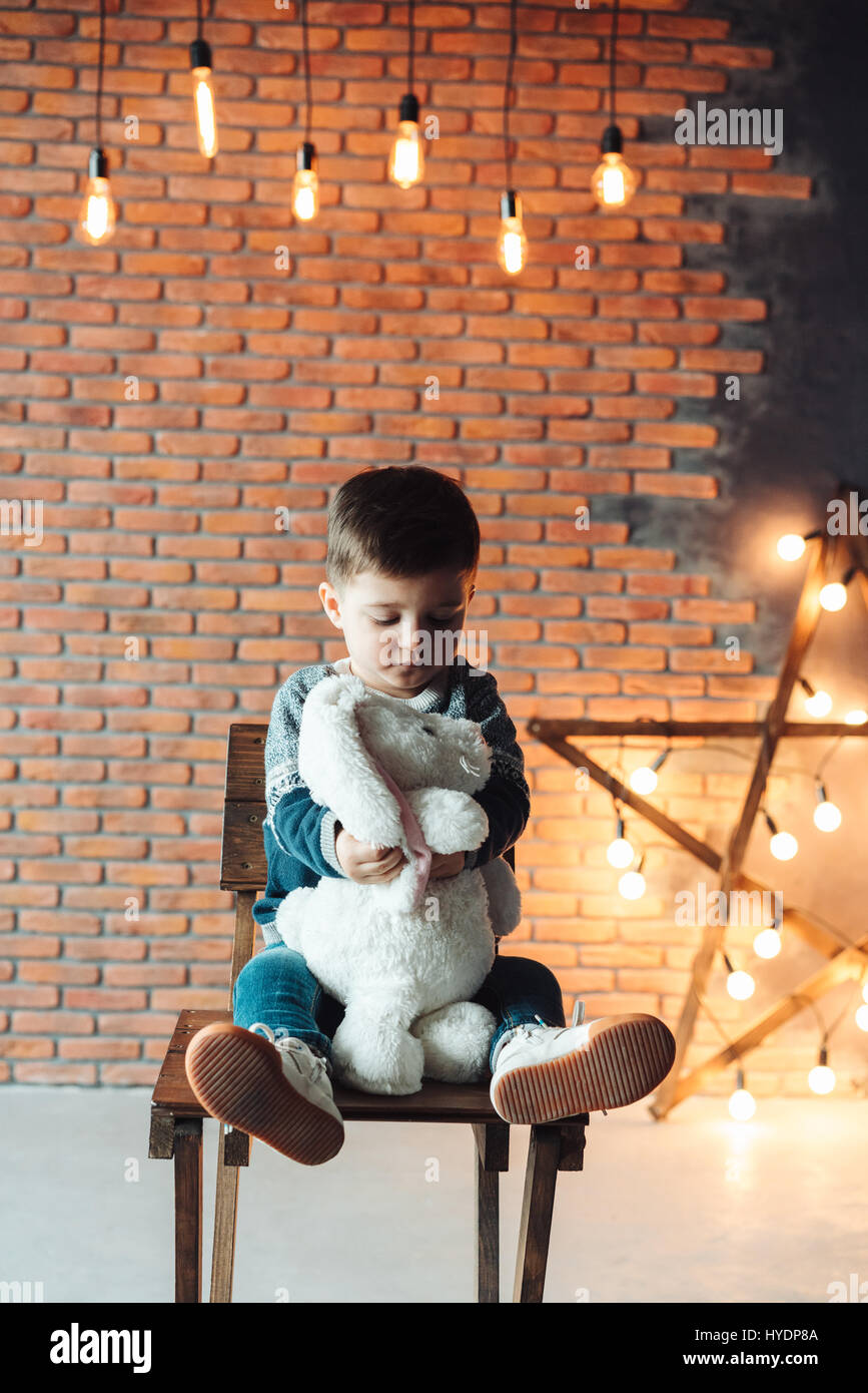 little boy sitting on a chair Stock Photo - Alamy