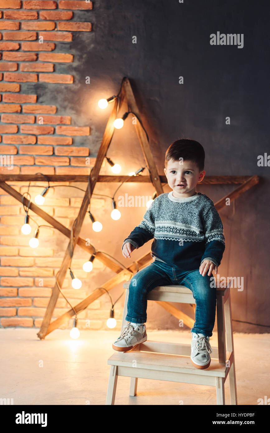 little boy sitting on a chair Stock Photo - Alamy